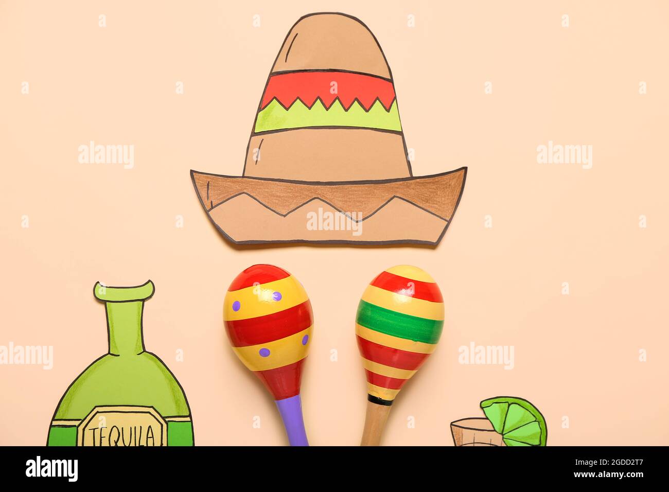 Mexican maracas, paper sombrero and tequila on color background Stock ...