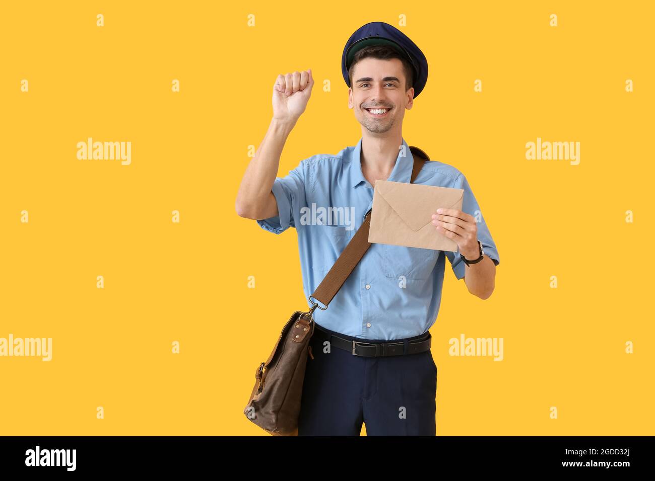 Handsome young postman with letter on color background Stock Photo - Alamy