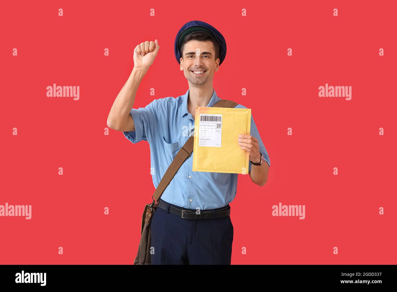 Handsome young postman with letter on color background Stock Photo - Alamy