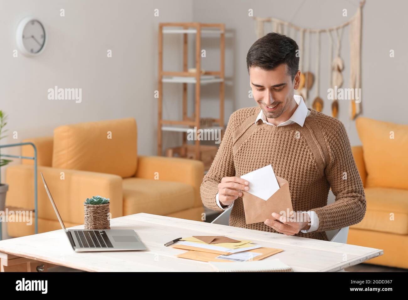 Young man with letter at home Stock Photo - Alamy