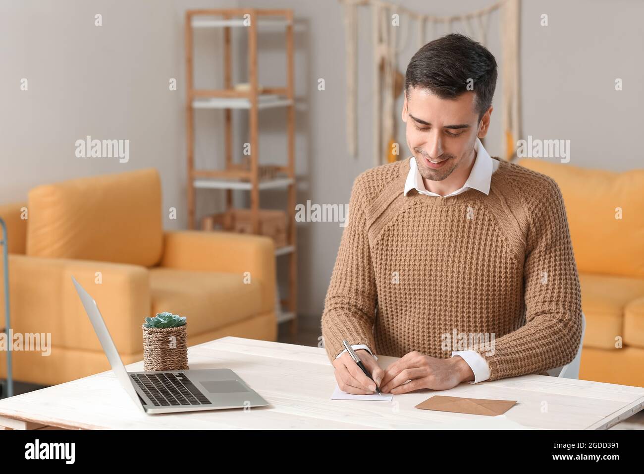 Young man writing letter at home Stock Photo - Alamy