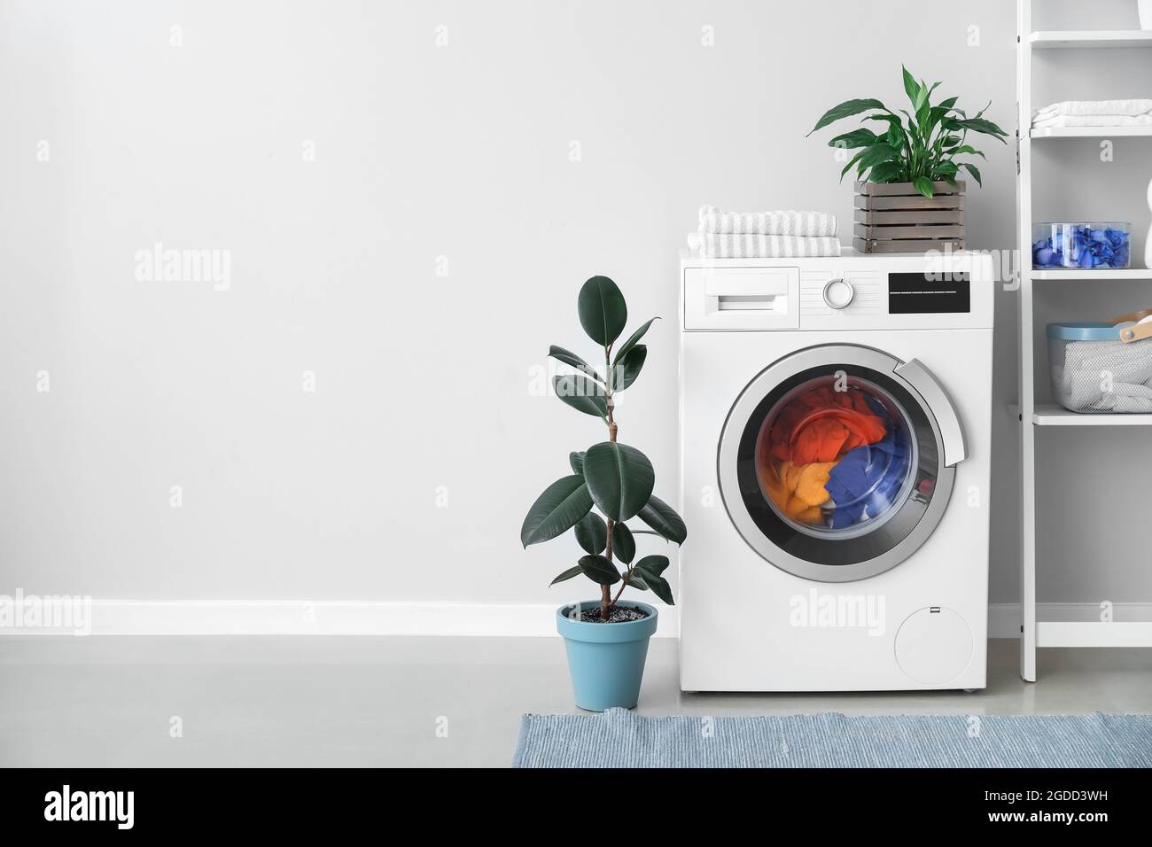 Interior of bathroom with modern washing machine Stock Photo - Alamy
