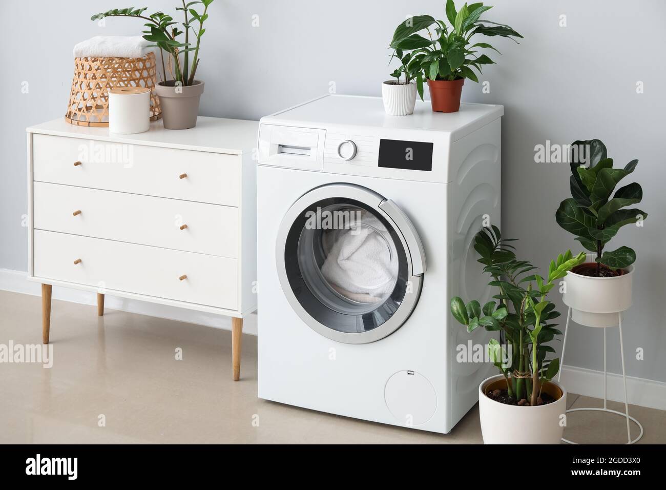 Interior of bathroom with modern washing machine Stock Photo - Alamy