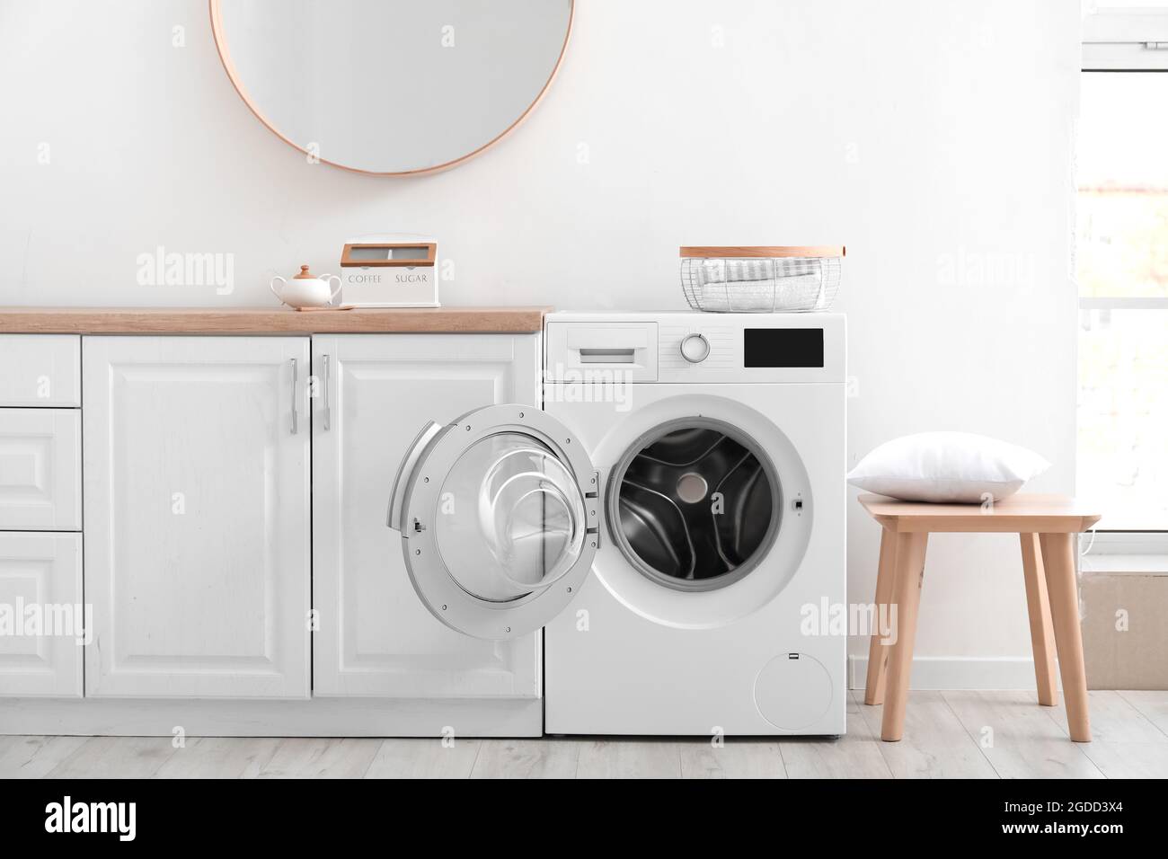Interior of kitchen with modern washing machine Stock Photo - Alamy
