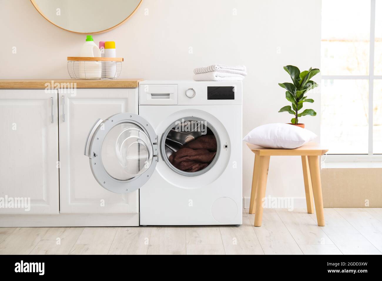 Interior of kitchen with modern washing machine Stock Photo - Alamy