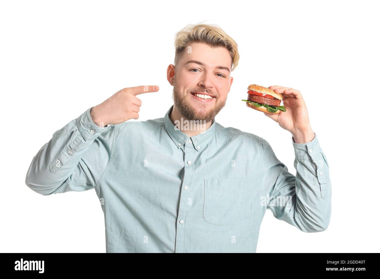 Young man pointing at tasty vegan burger on white background Stock ...