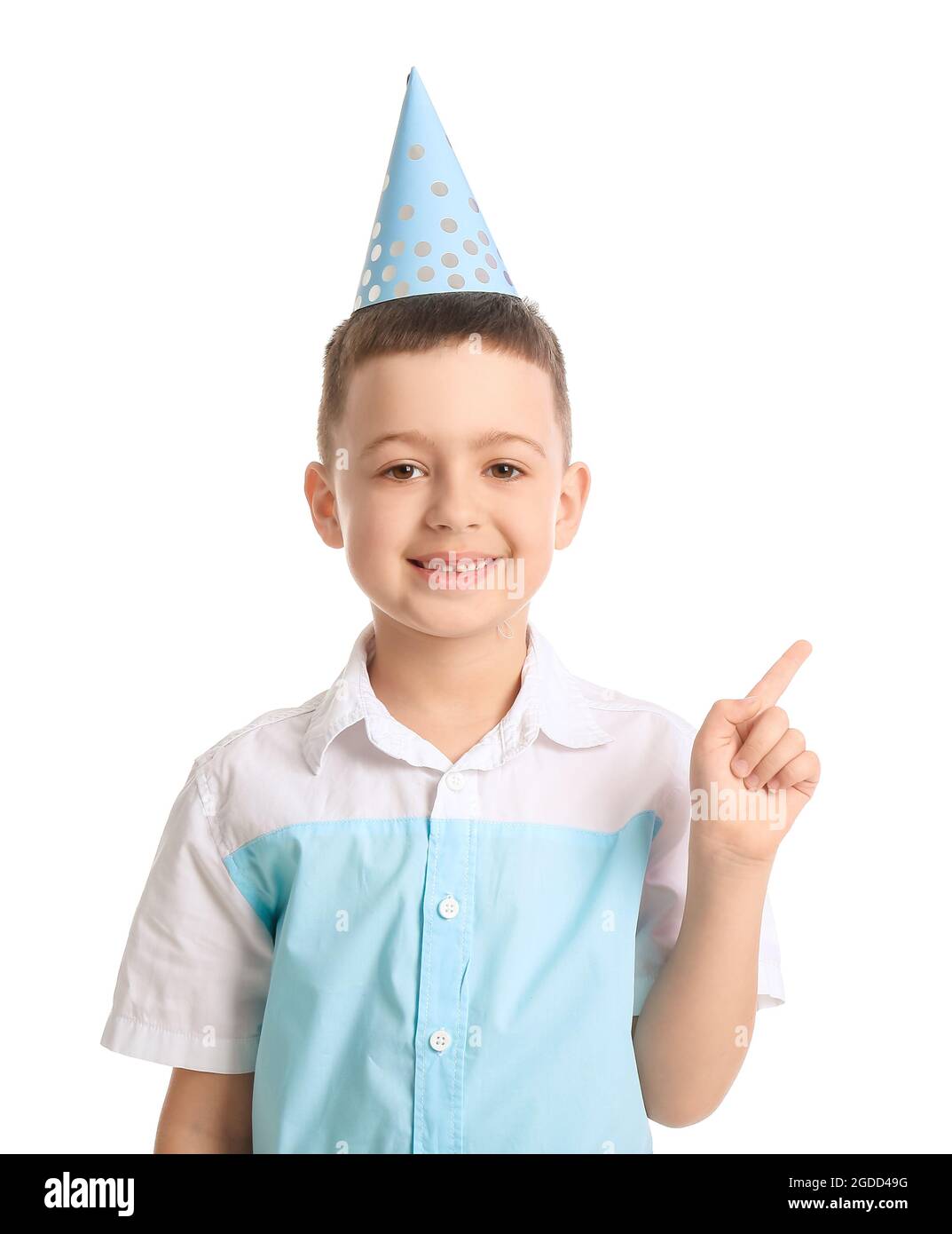 Little boy in party hat pointing at something on white background Stock ...