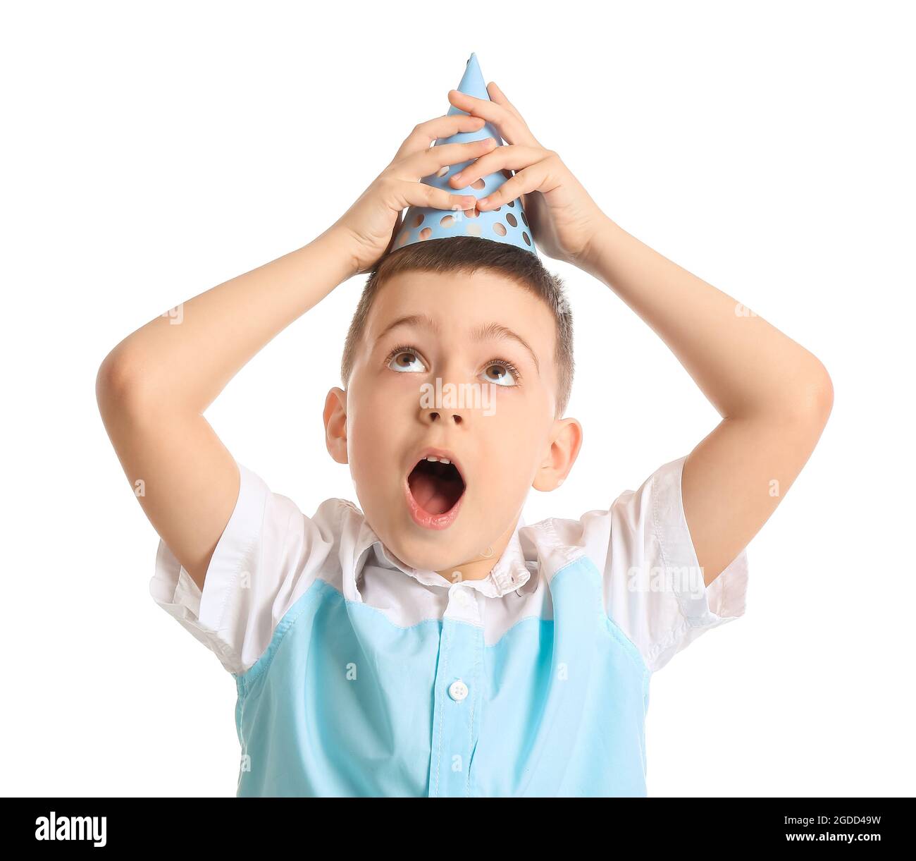 Surprised little boy in party hat on white background Stock Photo - Alamy