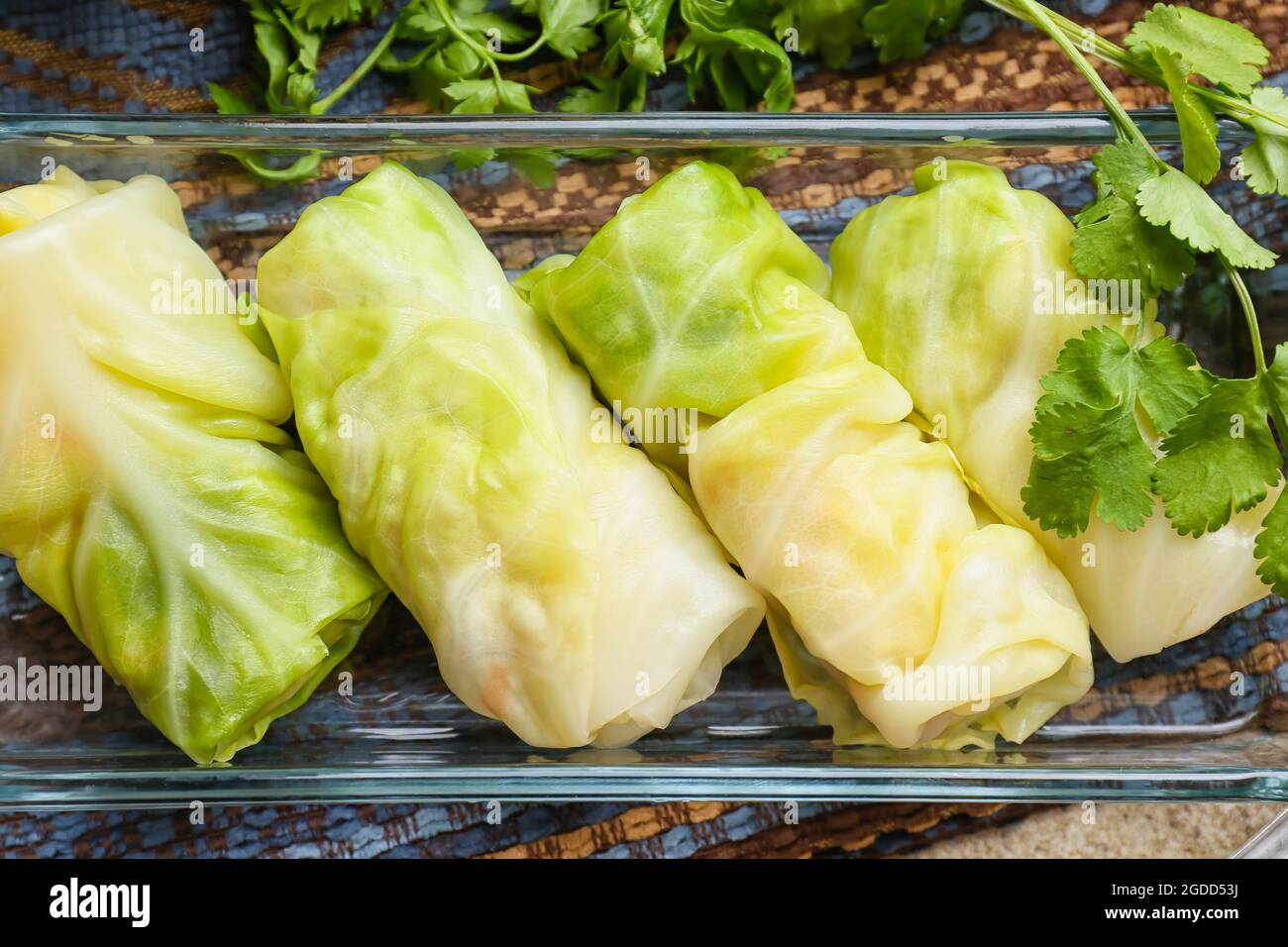 Baking dish with uncooked cabbage rolls on table, closeup Stock Photo ...