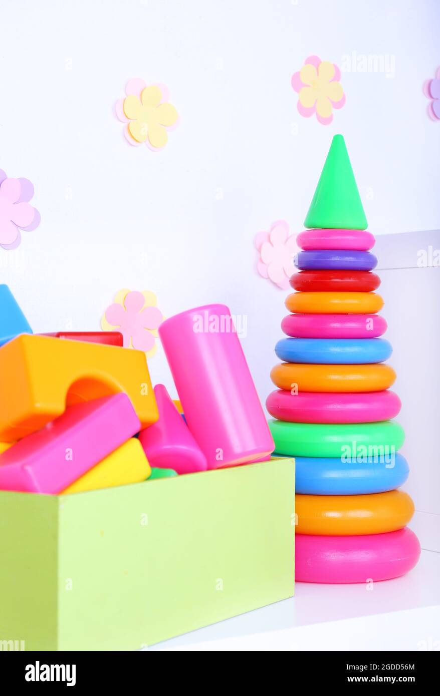 Colorful plastic toys on decorative Stock Photo - Alamy