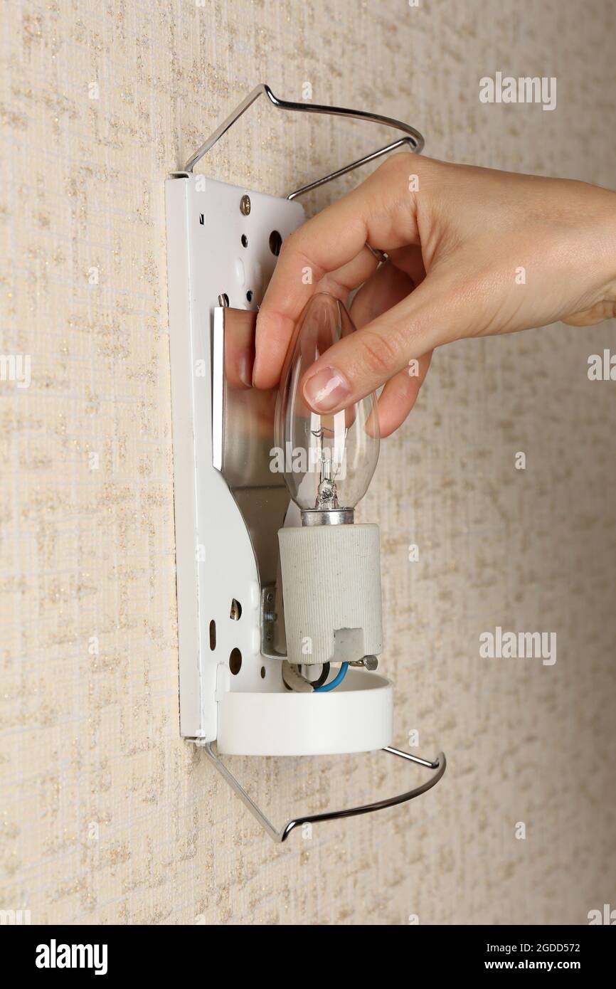 Hand changing light bulb at home Stock Photo - Alamy