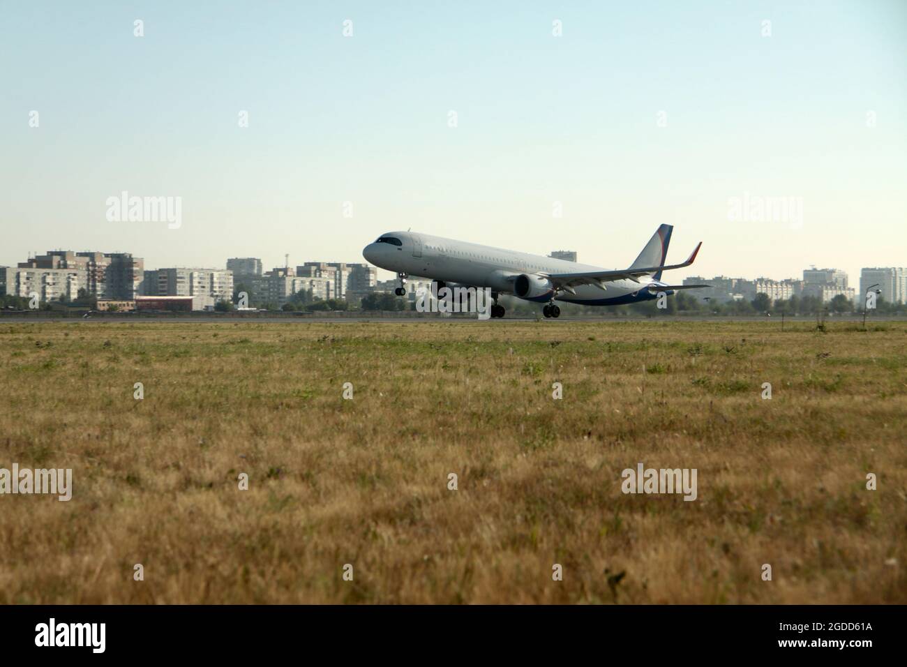 Passenger plane takes off from the airport runway. Side-view of ...
