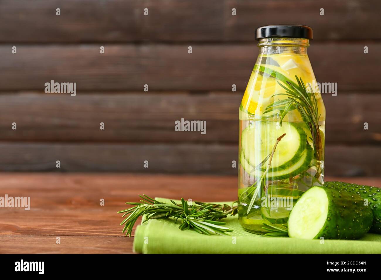 Bottle with cucumber lemonade on wooden background Stock Photo - Alamy
