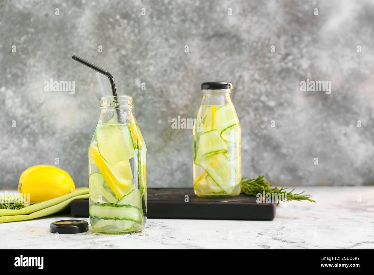 Bottles with cucumber lemonade on grunge background Stock Photo - Alamy