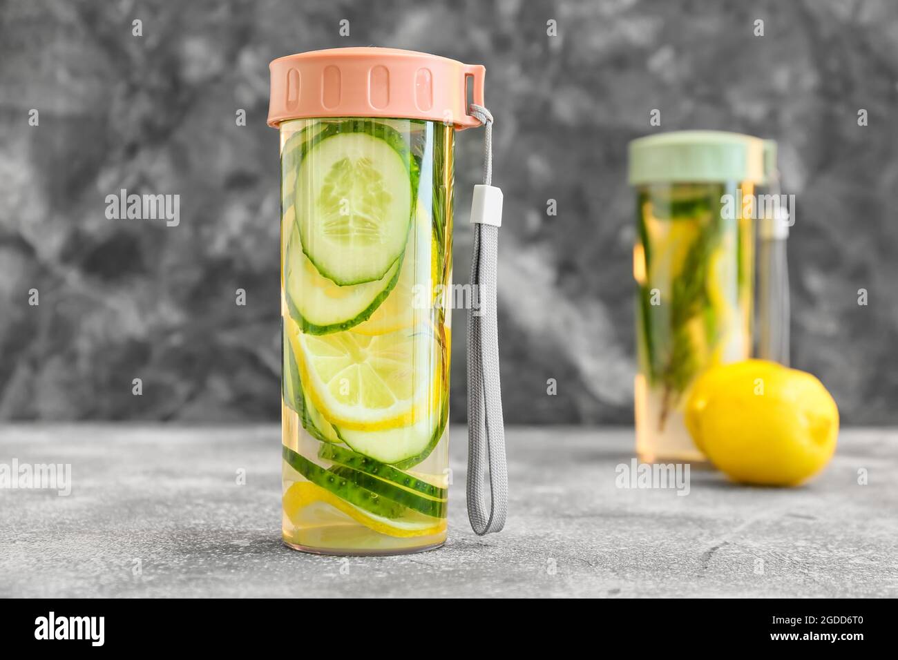 Bottles with cucumber lemonade on grunge background Stock Photo - Alamy
