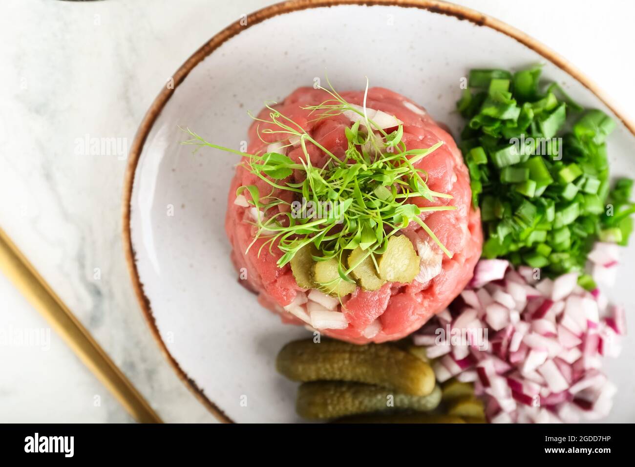 Plate with tasty beef tartare on light background, closeup Stock Photo ...