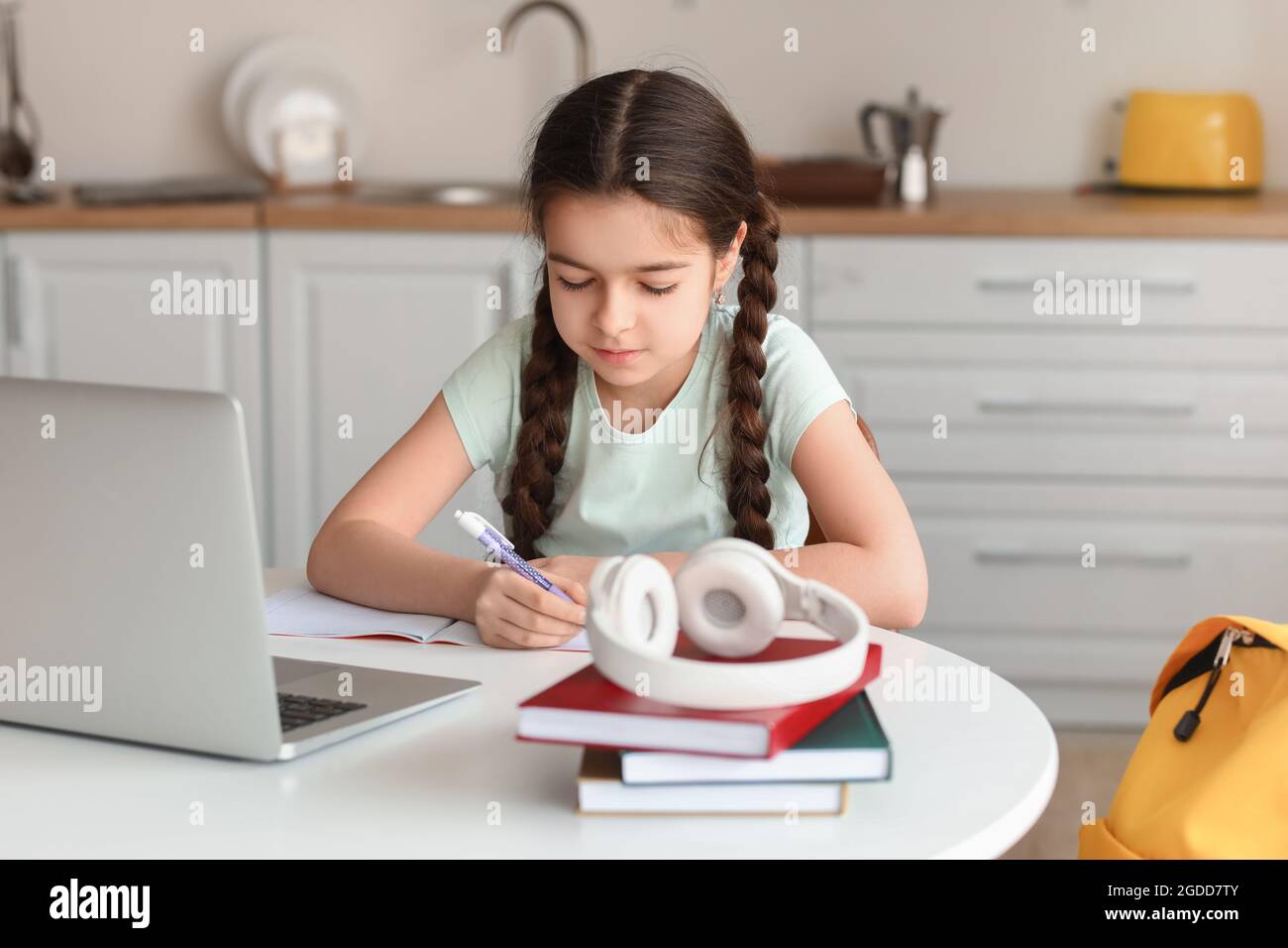 Little girl studying online at home Stock Photo - Alamy