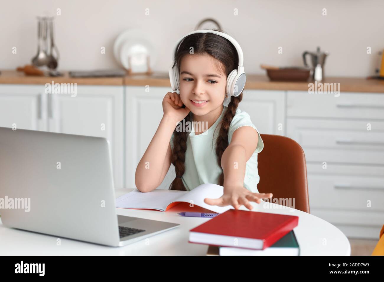 Little girl studying online at home Stock Photo - Alamy
