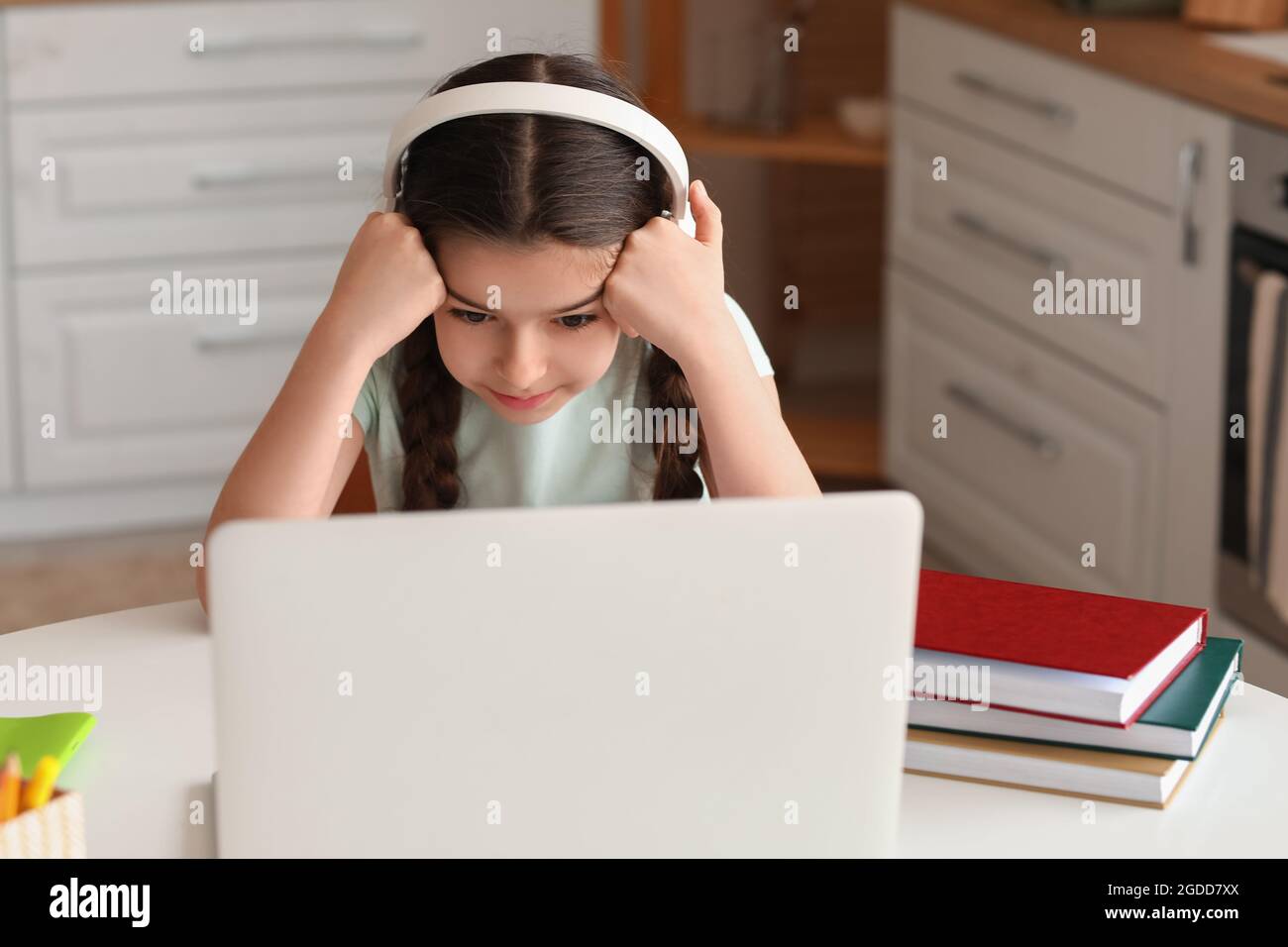 Little girl studying online at home Stock Photo - Alamy