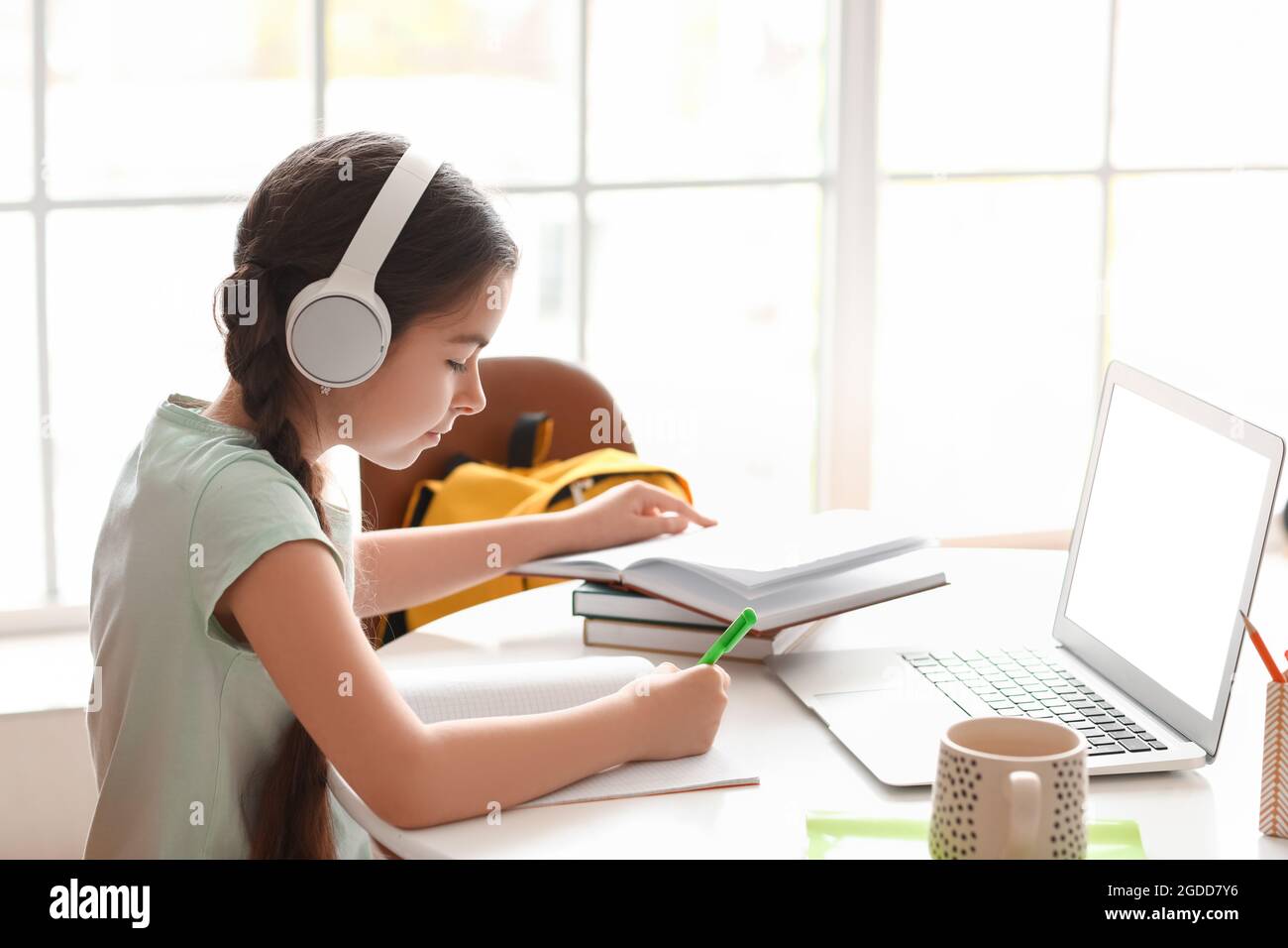 Little girl studying online at home Stock Photo - Alamy