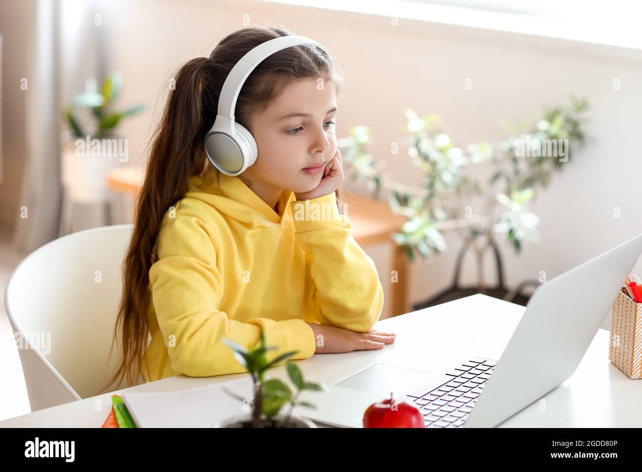 Little girl studying online at home Stock Photo - Alamy