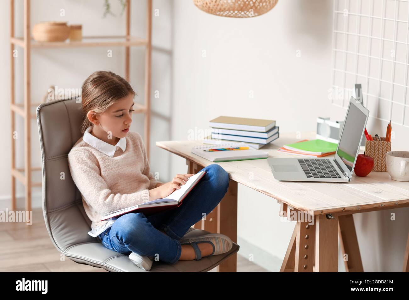 Little girl studying online at home Stock Photo - Alamy