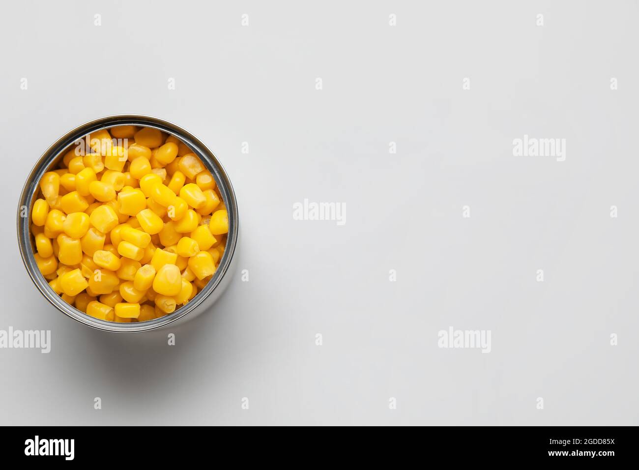 Opened tin can of corn kernels on white background Stock Photo - Alamy