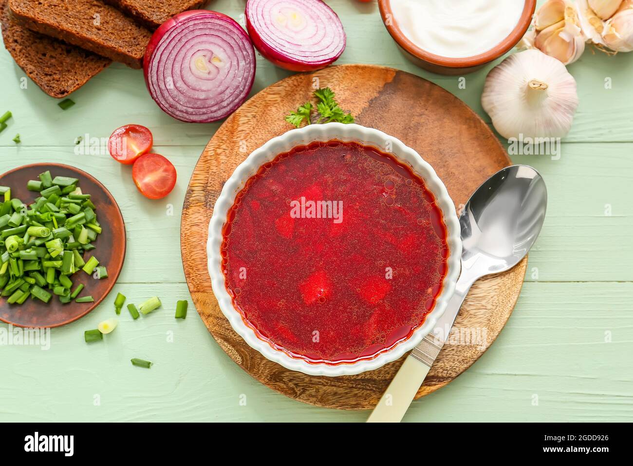 Composition with tasty borscht on color wooden background Stock Photo ...