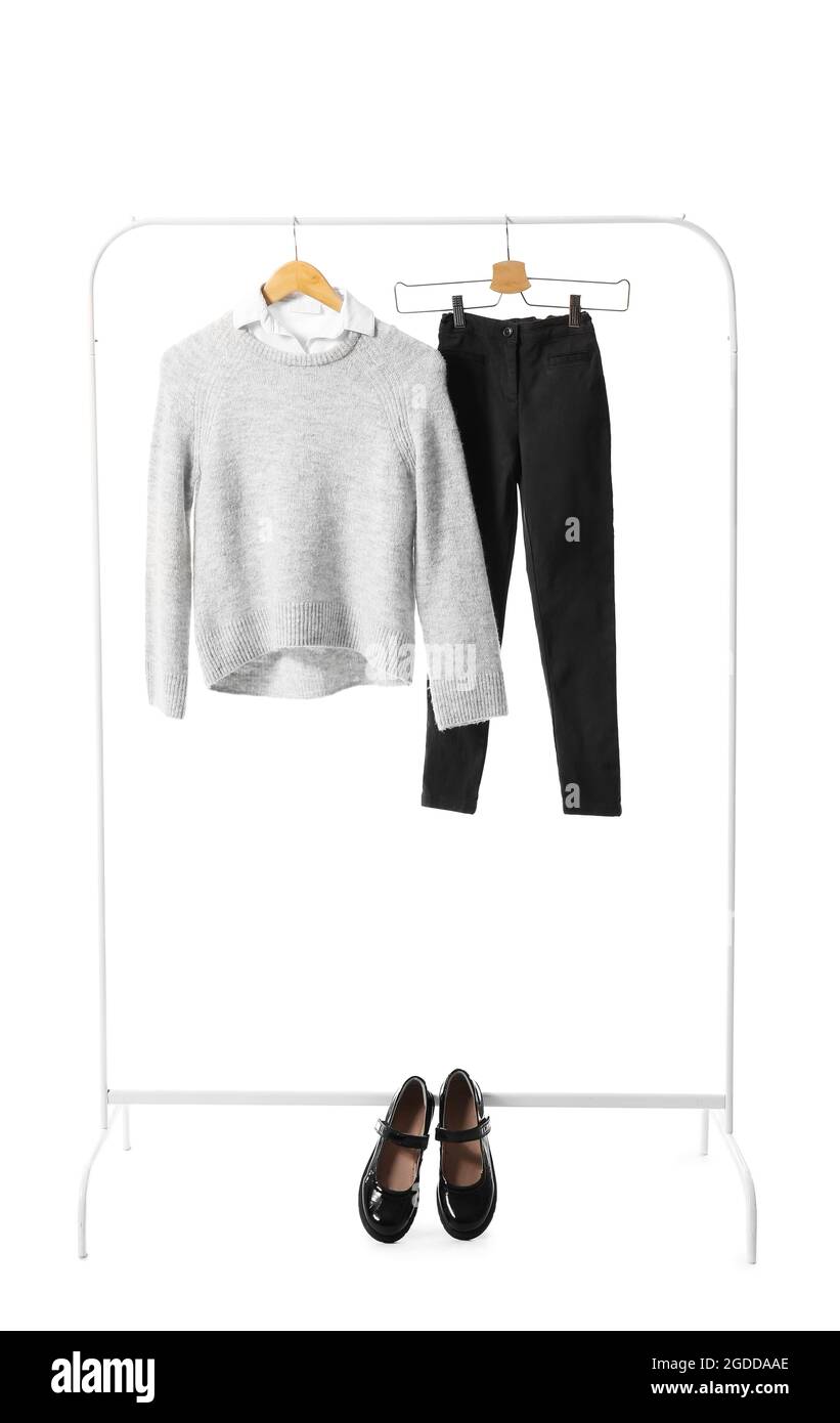 Rack with stylish school uniform on white background Stock Photo - Alamy