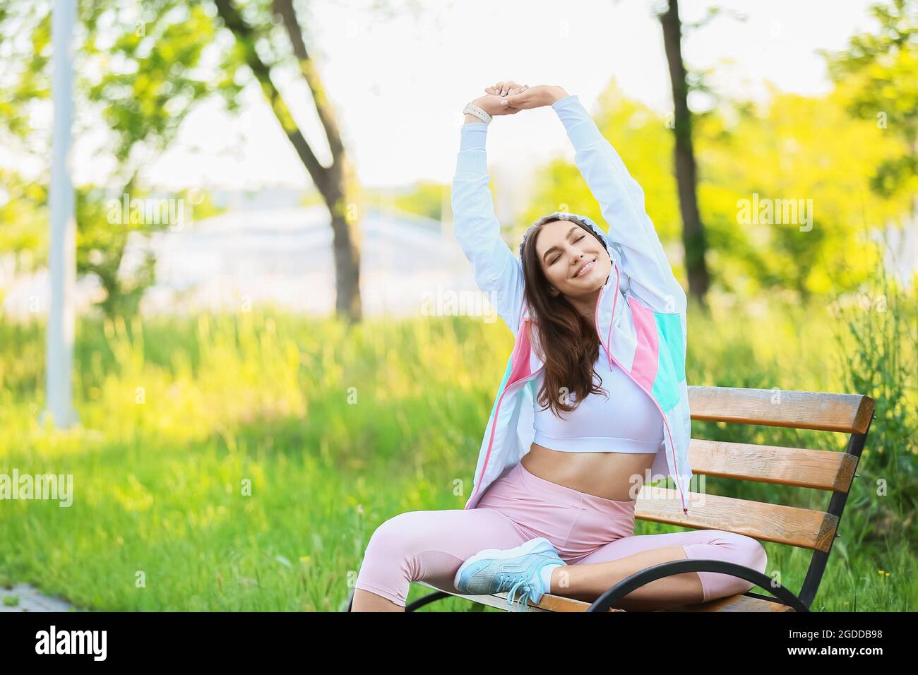 Sporty young woman resting after training outdoors Stock Photo - Alamy