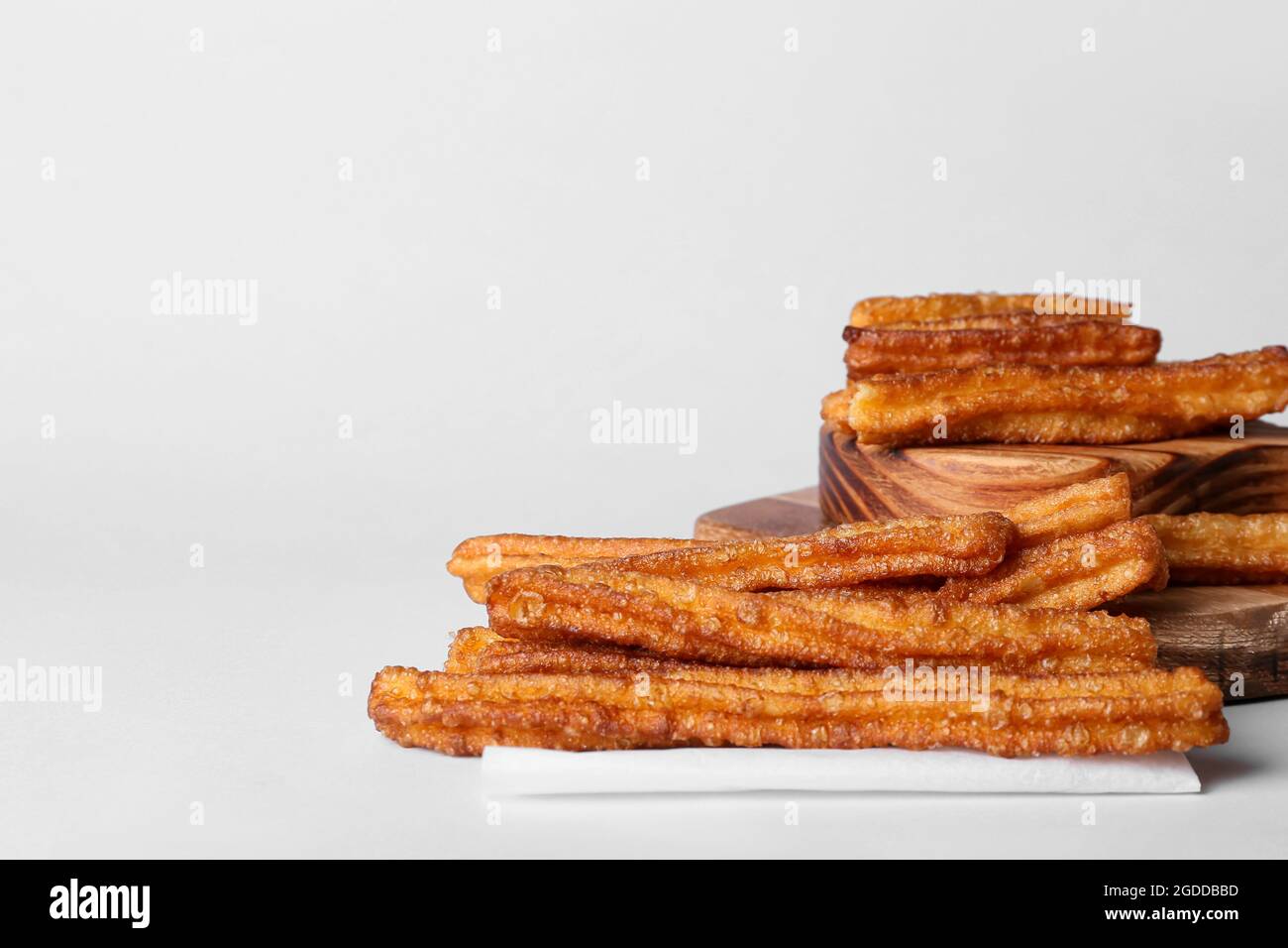 Boards with tasty churros on white background Stock Photo - Alamy