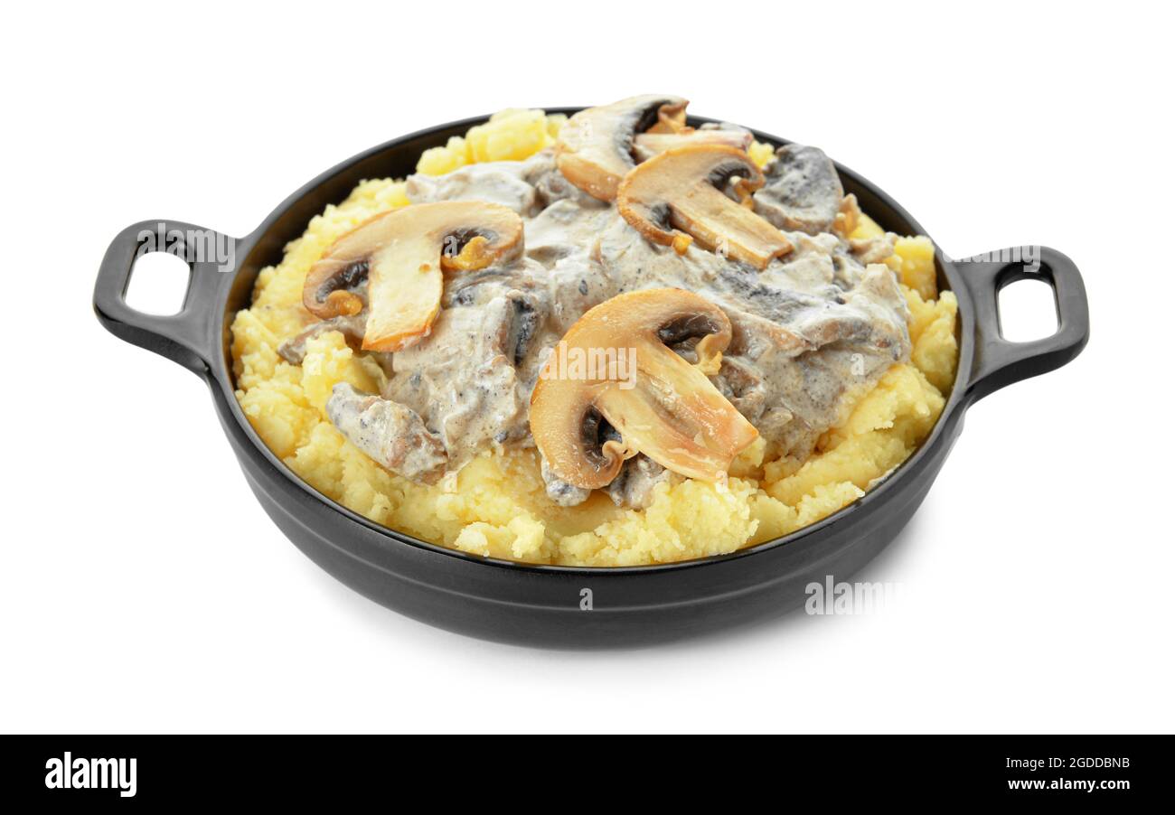 Frying pan with tasty mashed potatoes and mushrooms on white background ...
