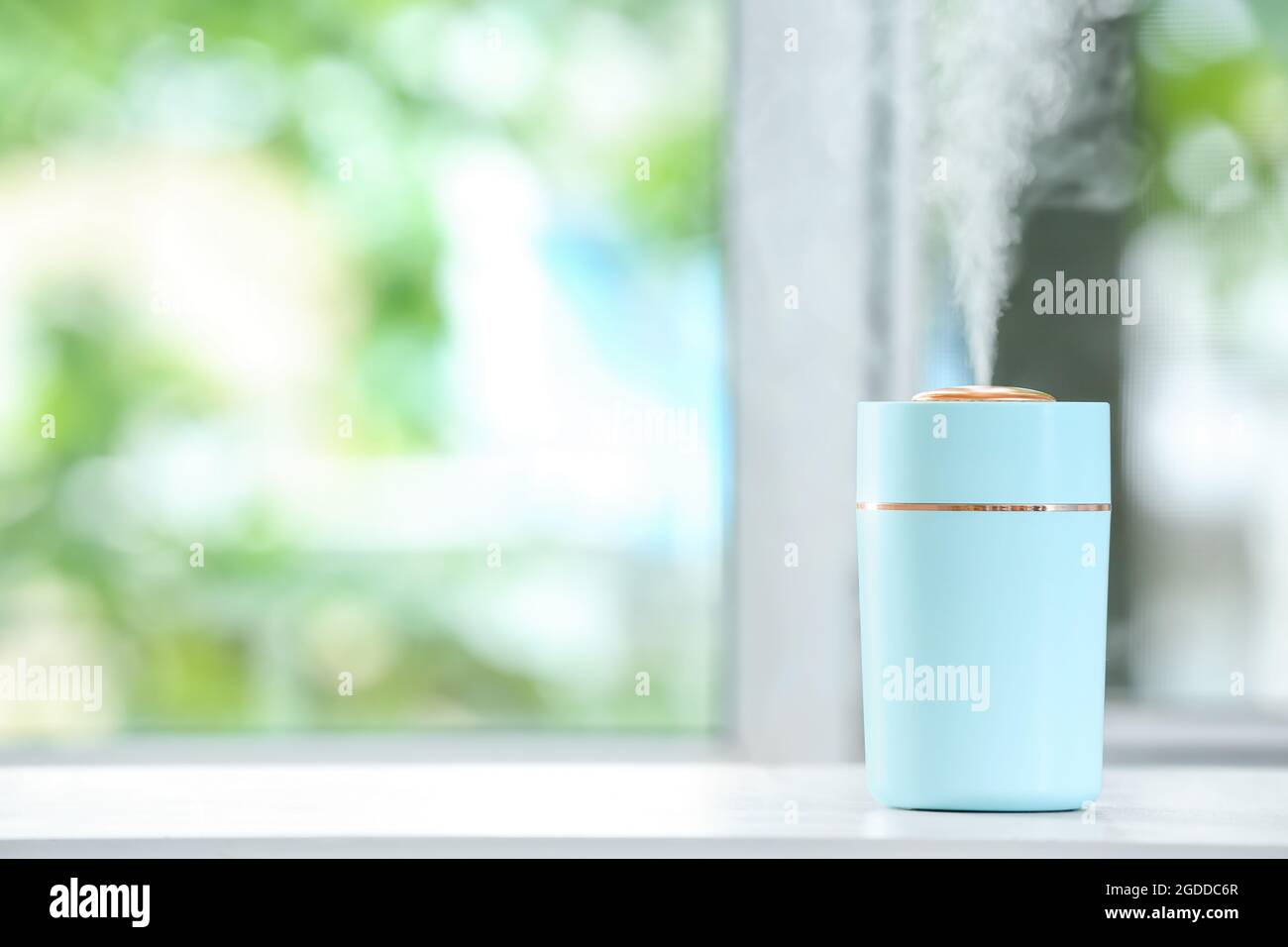 Modern humidifier on table in room Stock Photo - Alamy