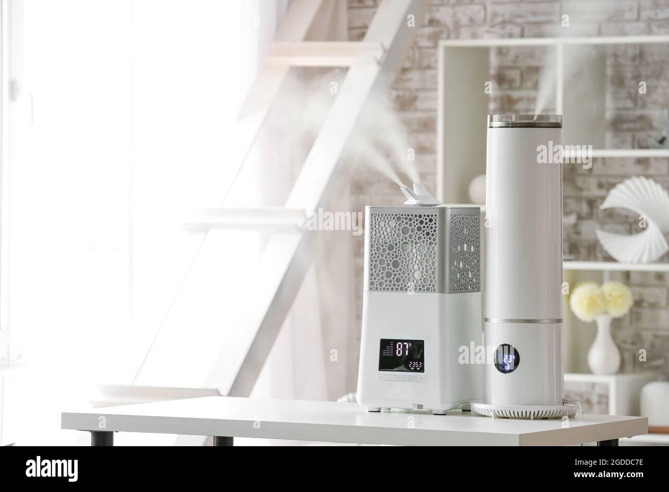 Modern humidifiers on table in room Stock Photo - Alamy