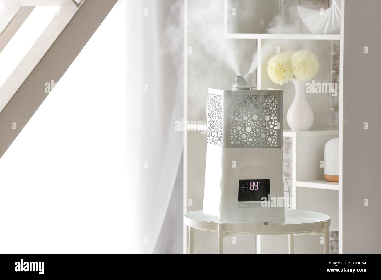 Modern humidifier on table in room Stock Photo - Alamy