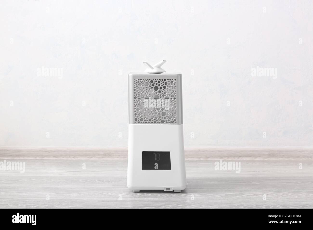 Modern humidifier on floor in room Stock Photo - Alamy