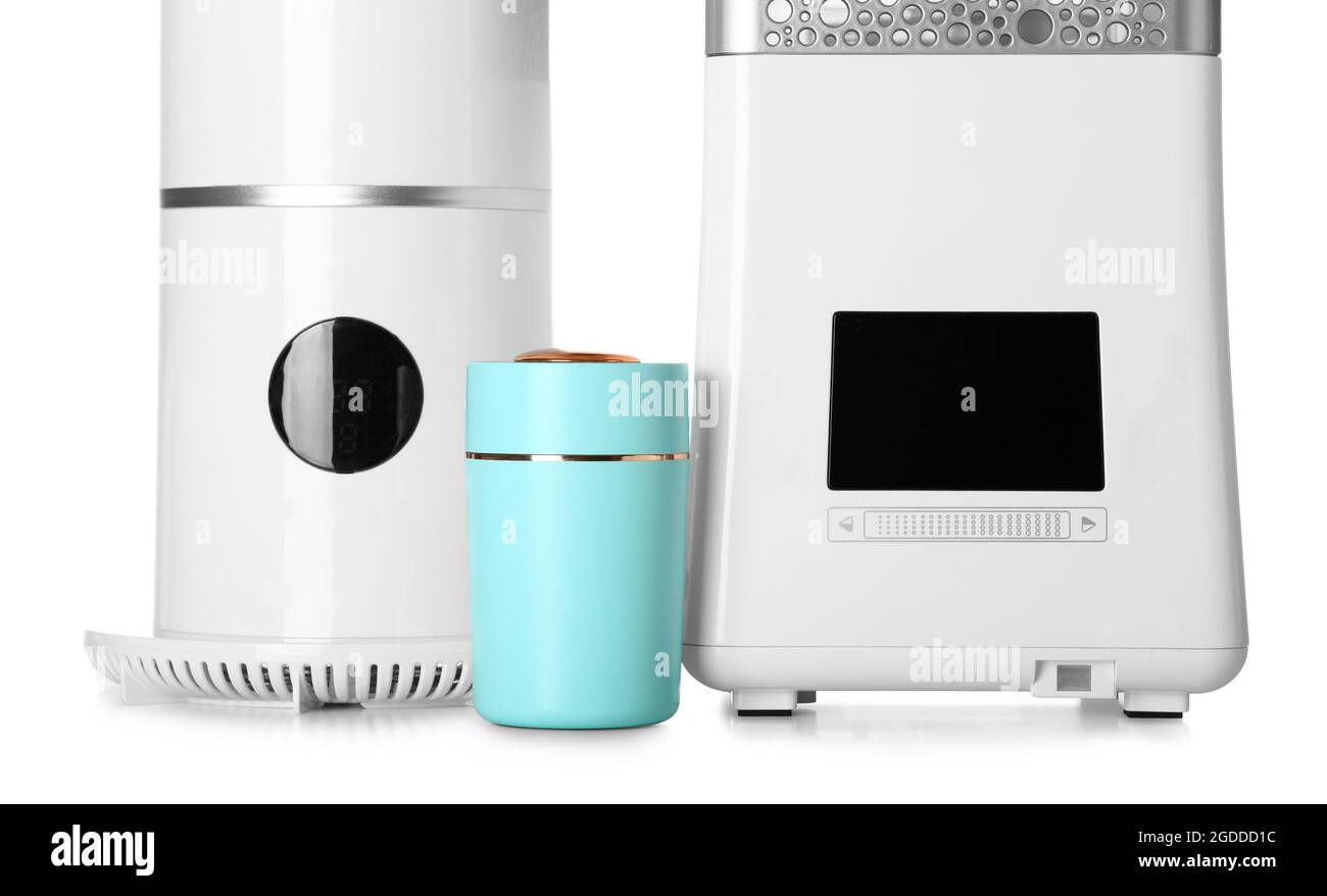 Modern humidifiers on white background Stock Photo - Alamy