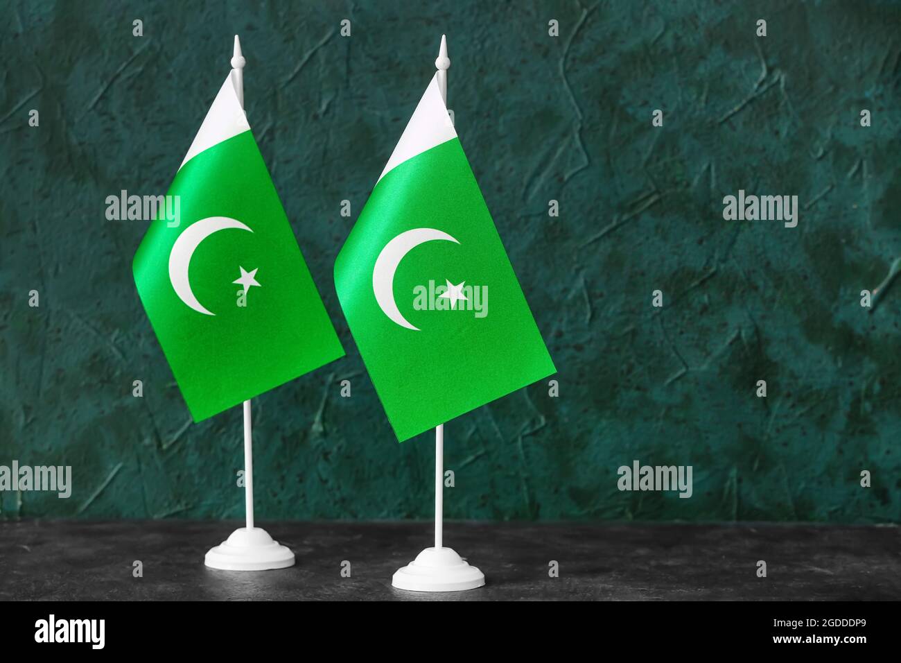 Pakistan flags on dark background Stock Photo - Alamy