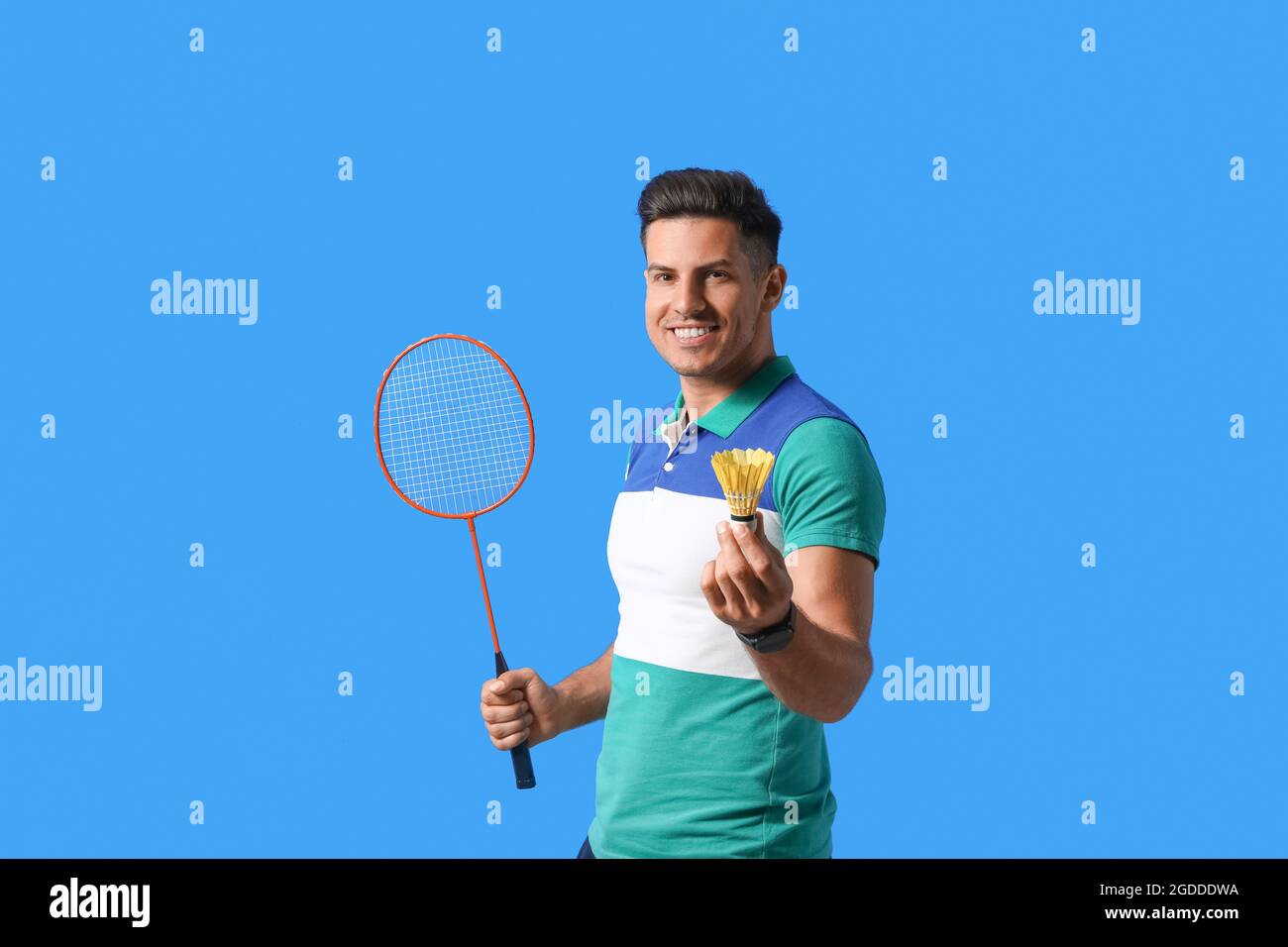 Sporty male badminton player on color background Stock Photo - Alamy