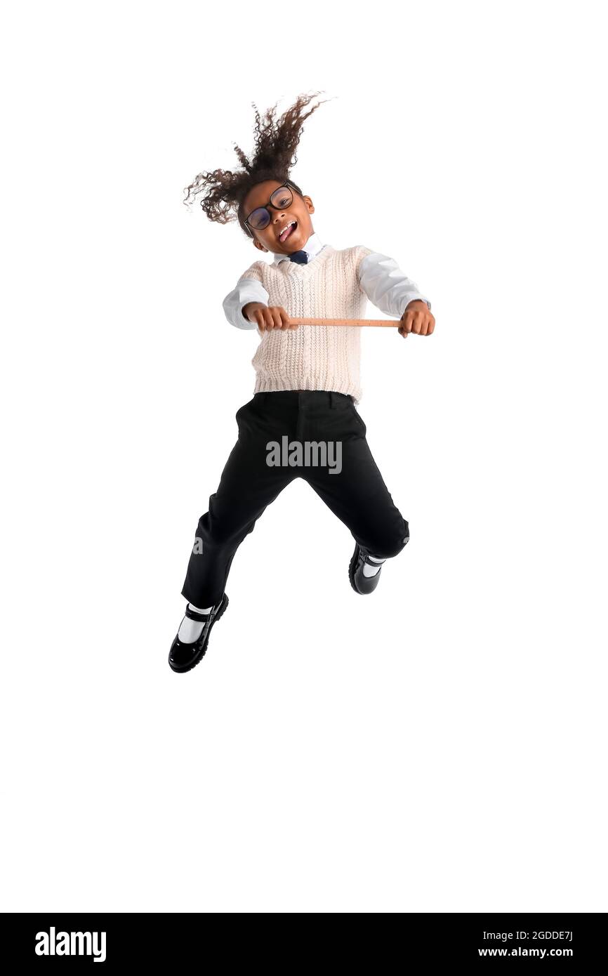 Jumping African-American schoolgirl with ruler on white background ...