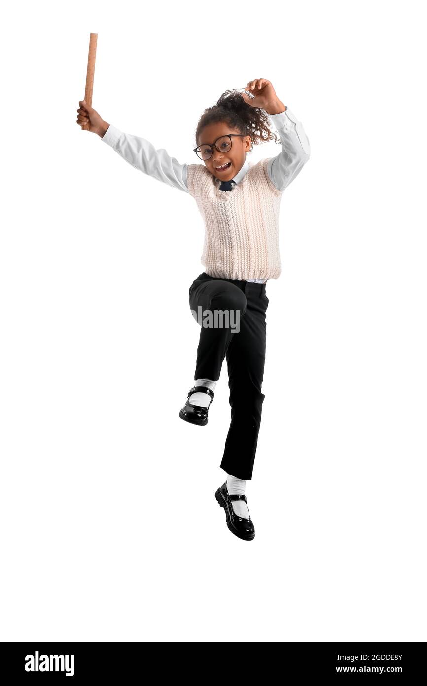 Jumping African-American schoolgirl with ruler on white background ...