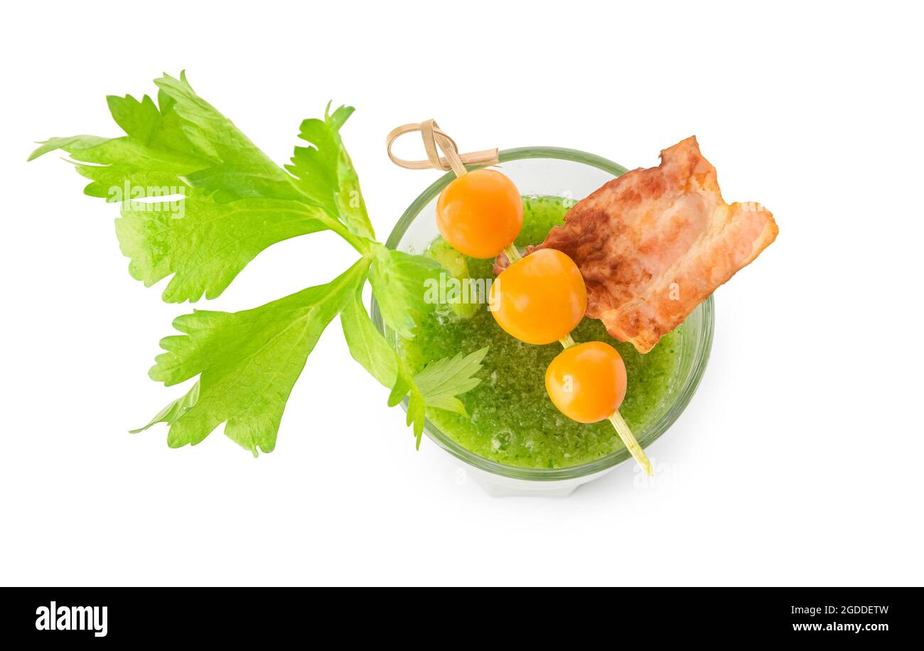 Glass of bloody Mary cocktail garnished with bacon, cape gooseberry and ...