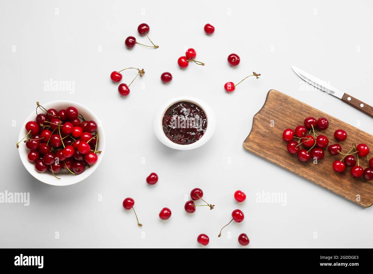 Composition with ripe cherry and jam on white background Stock Photo ...