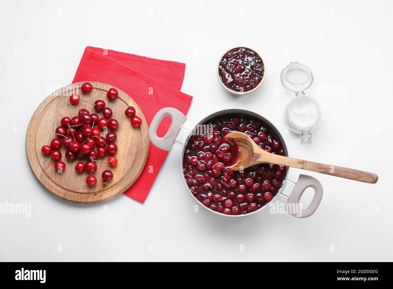 Composition with tasty cherry jam on white background Stock Photo - Alamy
