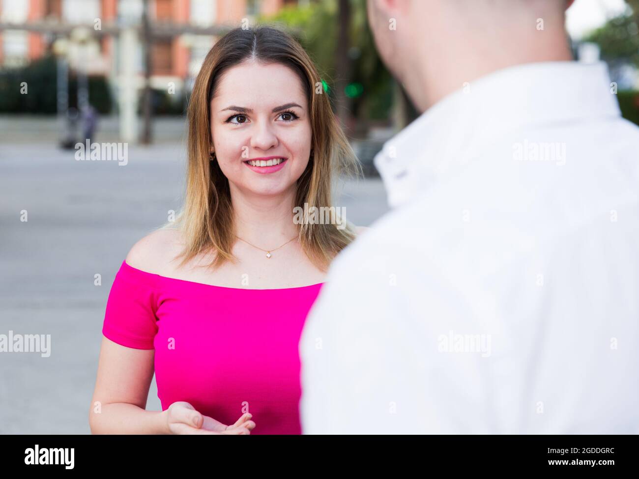 Young woman is playful talking with stranger man Stock Photo - Alamy