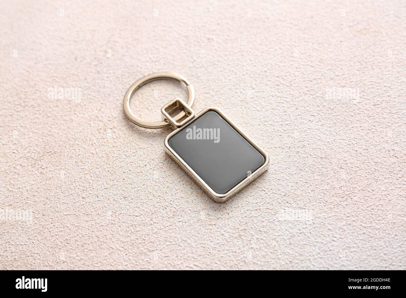Stylish keychain on light background Stock Photo - Alamy