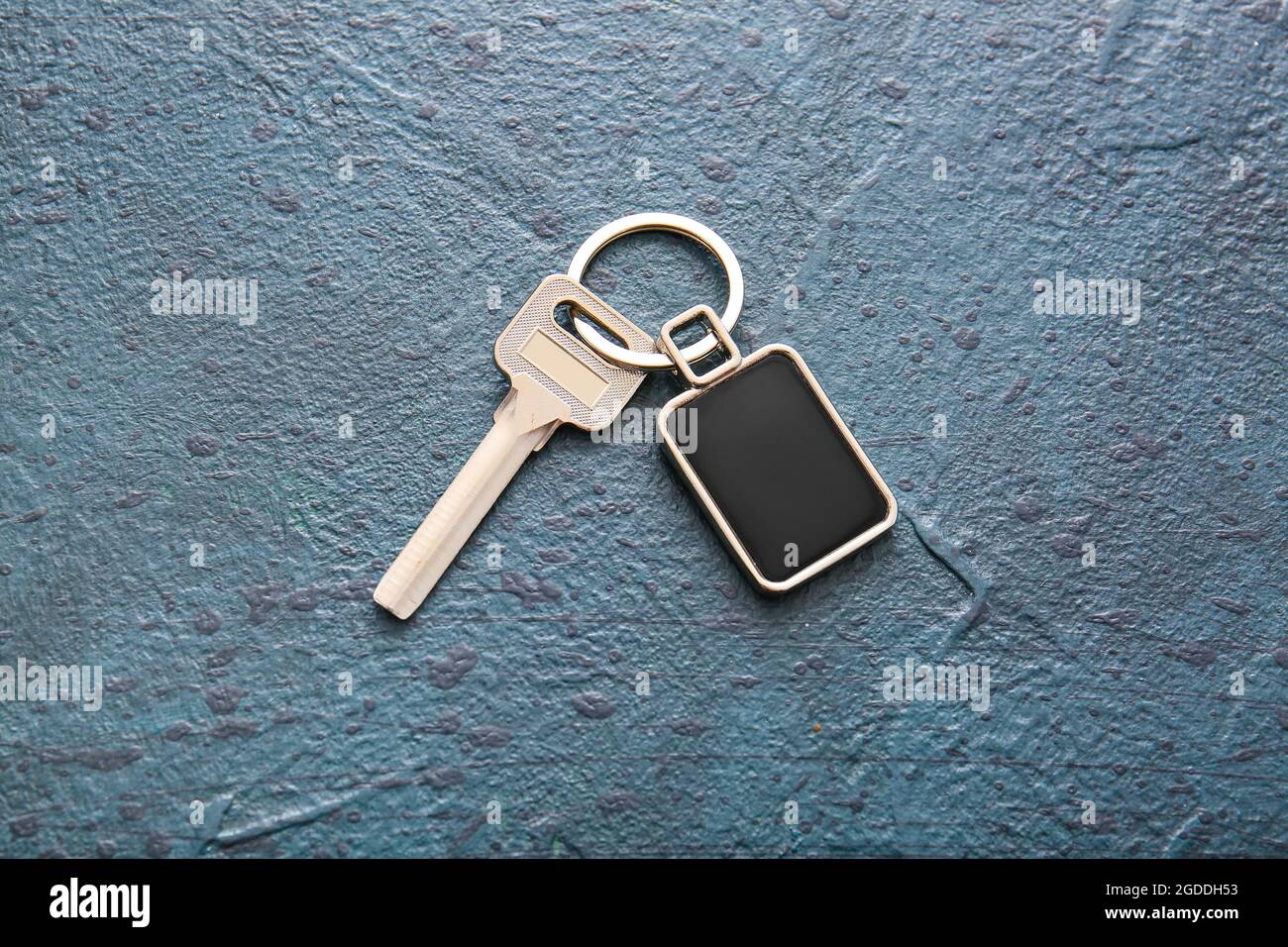 Key with stylish keychain on dark background Stock Photo - Alamy