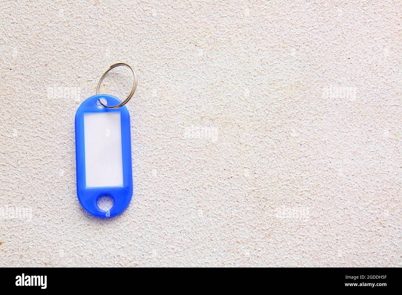 Plastic key tag on light background Stock Photo - Alamy