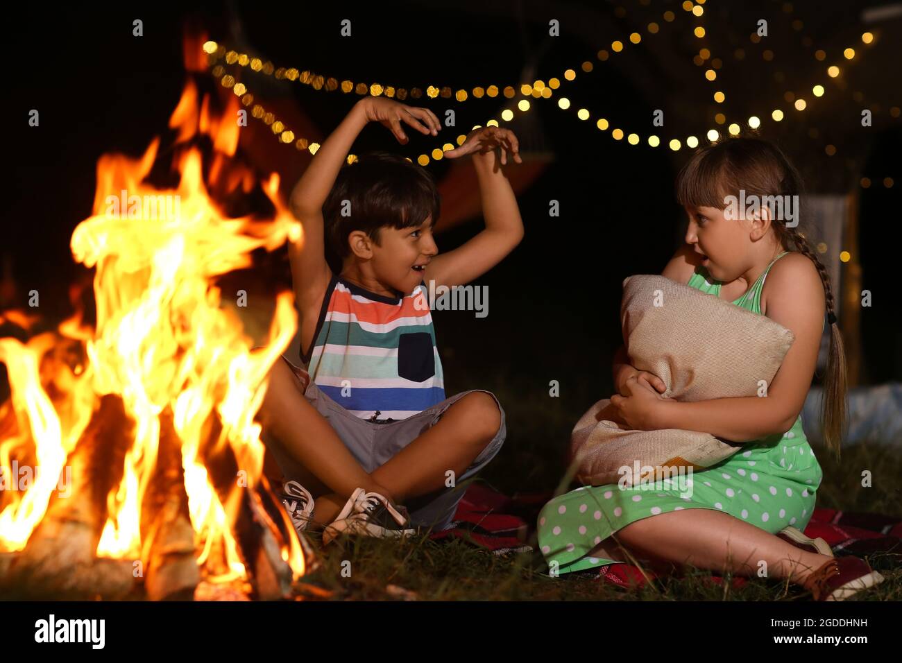 Little children near fire on summer evening Stock Photo - Alamy