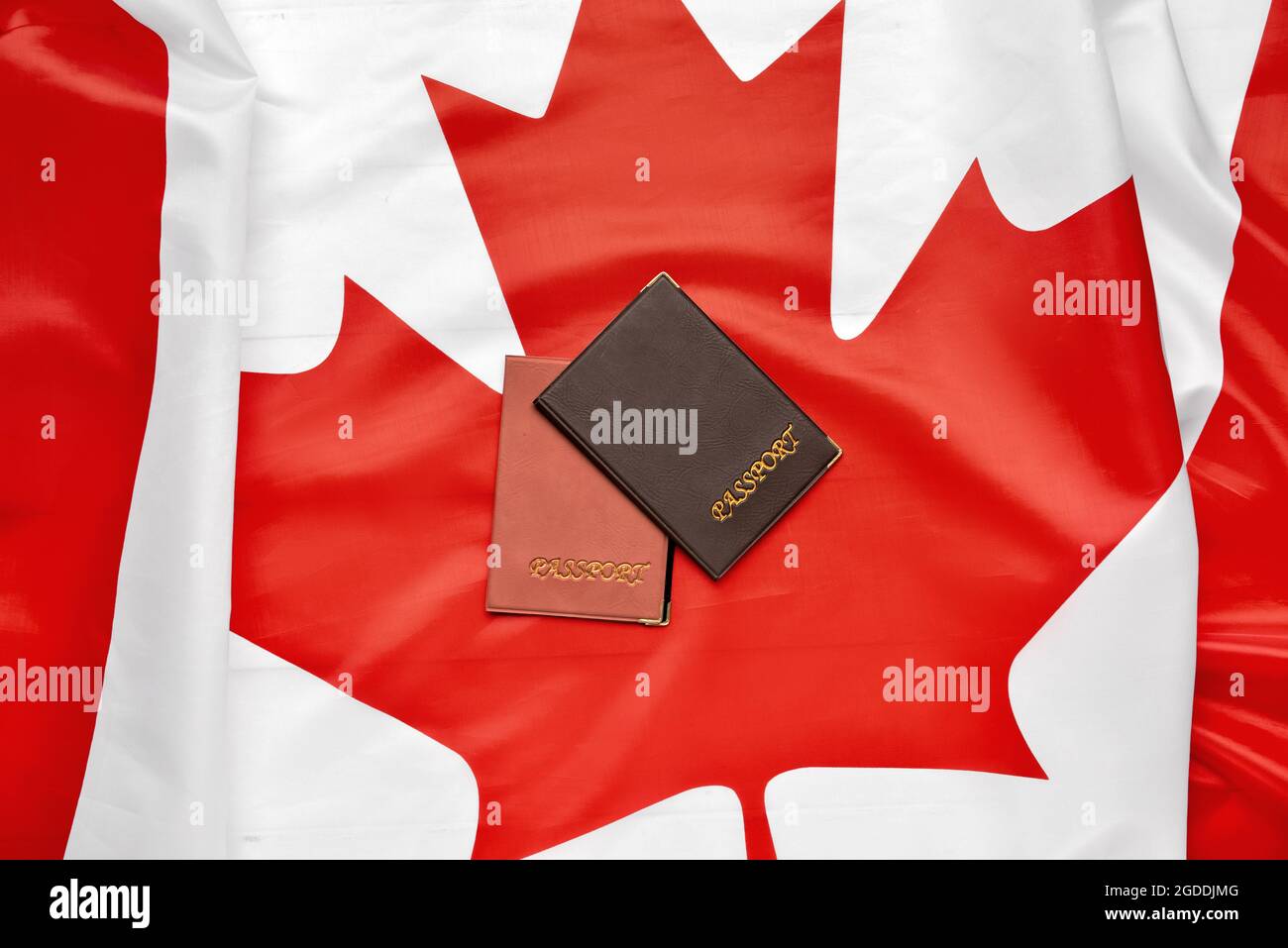 Passports on flag of Canada Stock Photo - Alamy